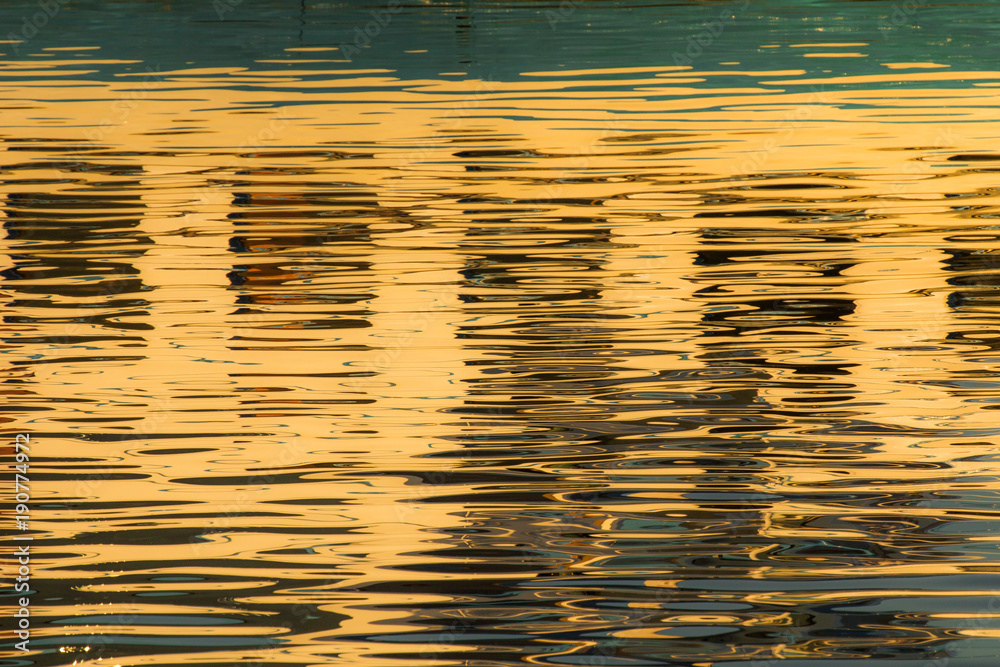 Reflection of windows in the waters of lake created by the light of the ...