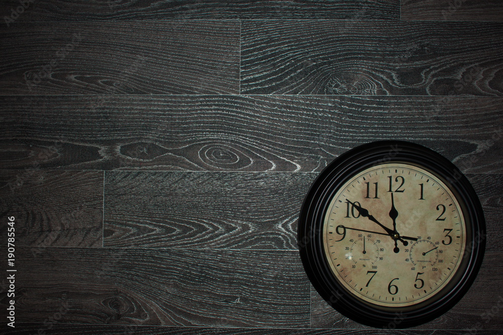 old retro black wall clock on dark wooden background Stock Photo ...