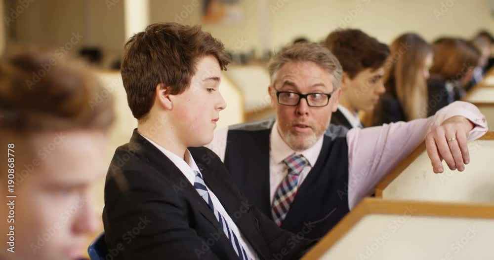 4k, Frustrated mature school teacher scolding a boy in a computer lab ...
