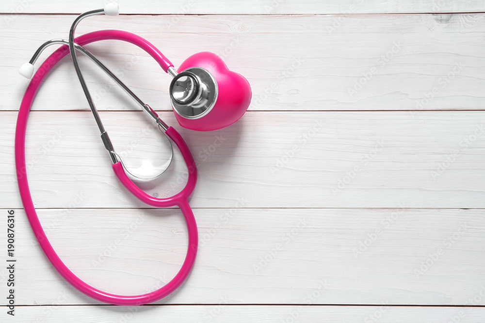 pink heart check with stethoscope medical instrument on top view white ...