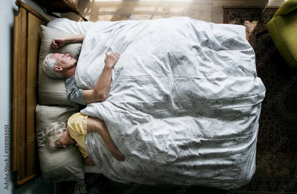 Elderly Caucasian couple sleeping on the bed Stock Photo | Adobe Stock