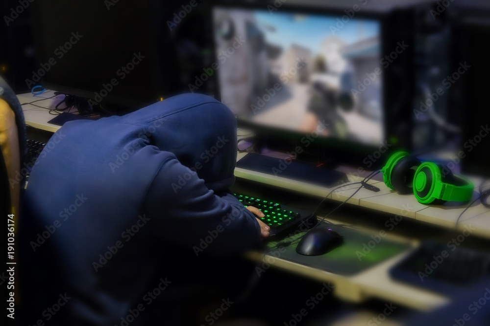 Tried gamer Sleeping in front of games monitor at internet cafe, game ...