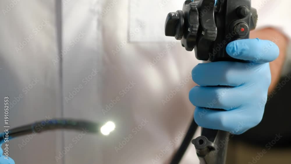 Doctor gastroenterologist with probe to perform gastroscopy and ...