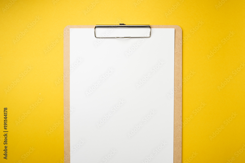 Clipboard With Yellow Paper