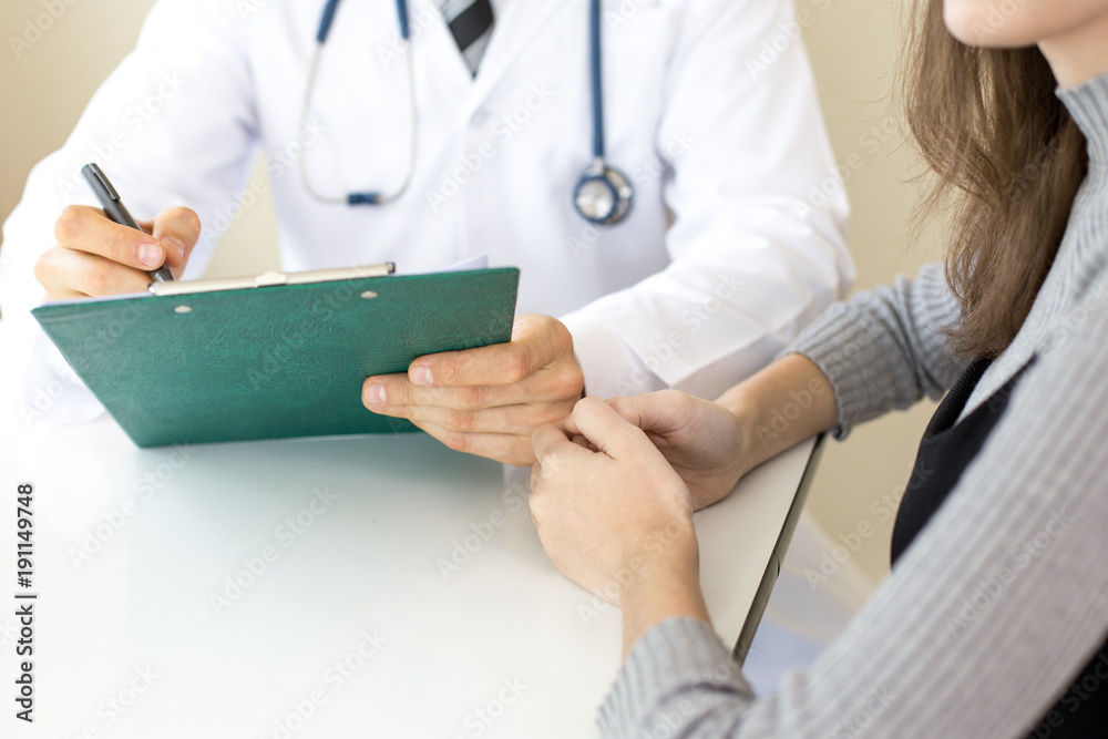 Doctor checking detail for treat patient at clinic. People with medical ...