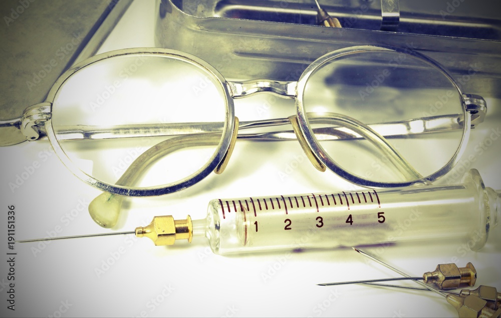 old fashioned vintage style silver of a doctor and the old glass ...