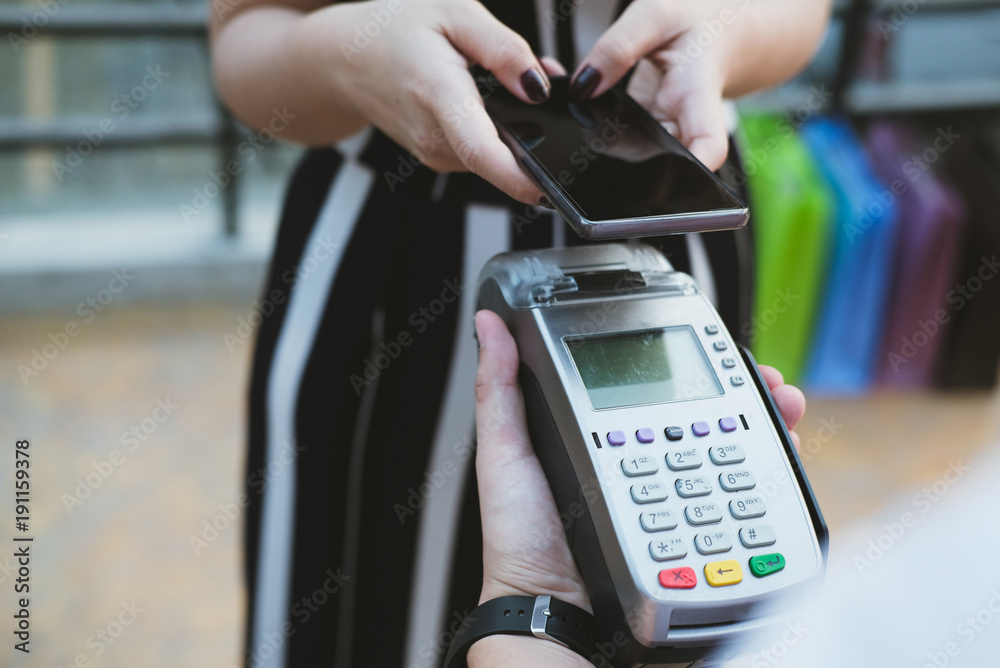 woman use smartphone to make mobile payment with electronic reader ...
