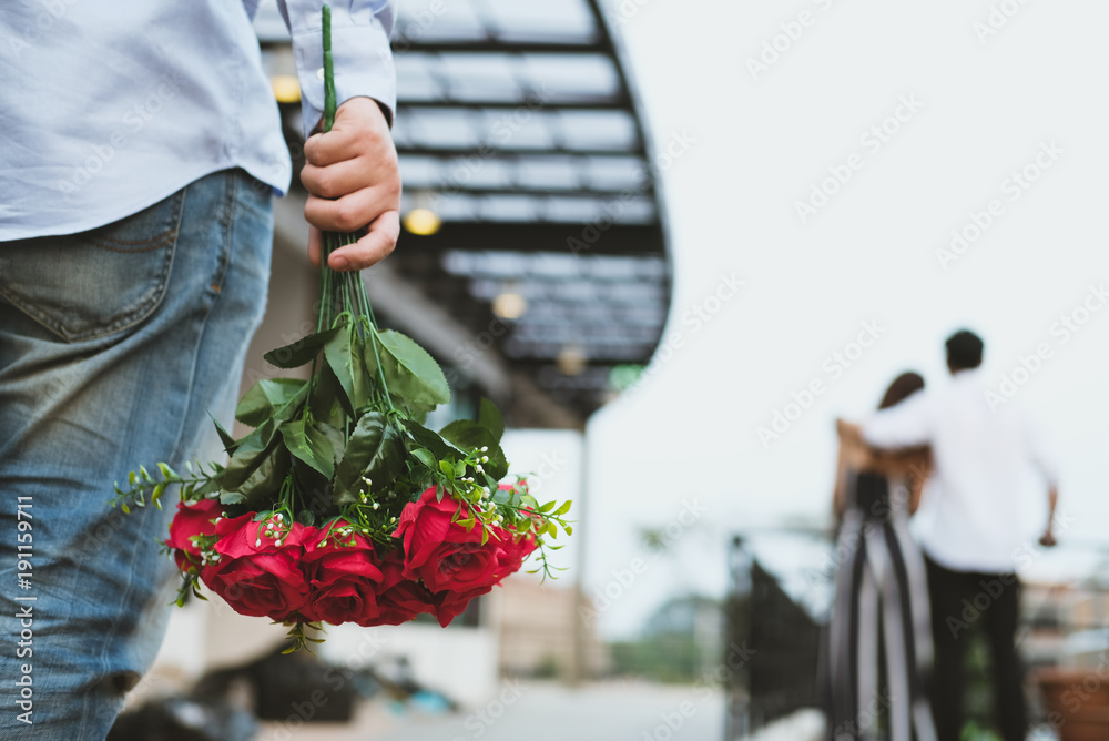 heartbroken man holding bouquet of red roses feeling sad while seeing ...