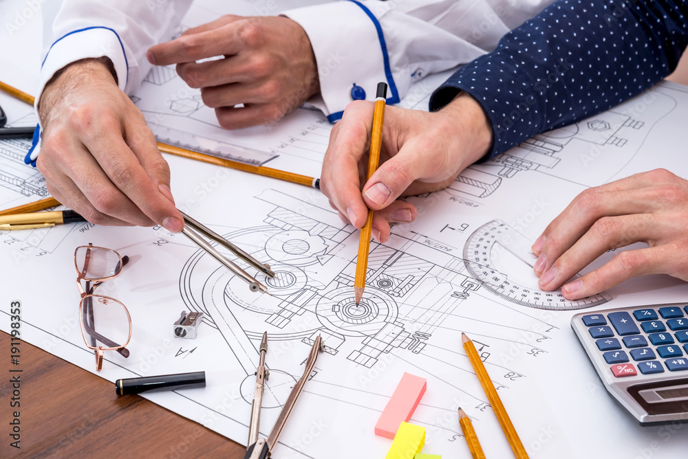 Two engineers discussing an engineering drawing office Stock Photo ...