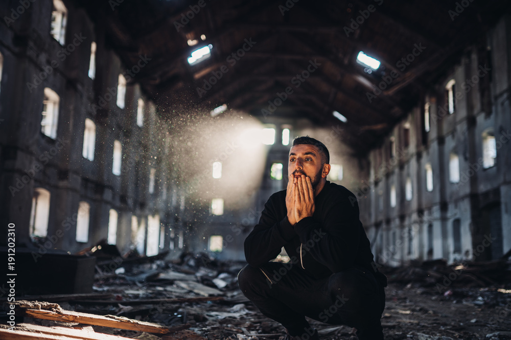 Sad depressed person in abandoned destroyed building crying.Emotional ...