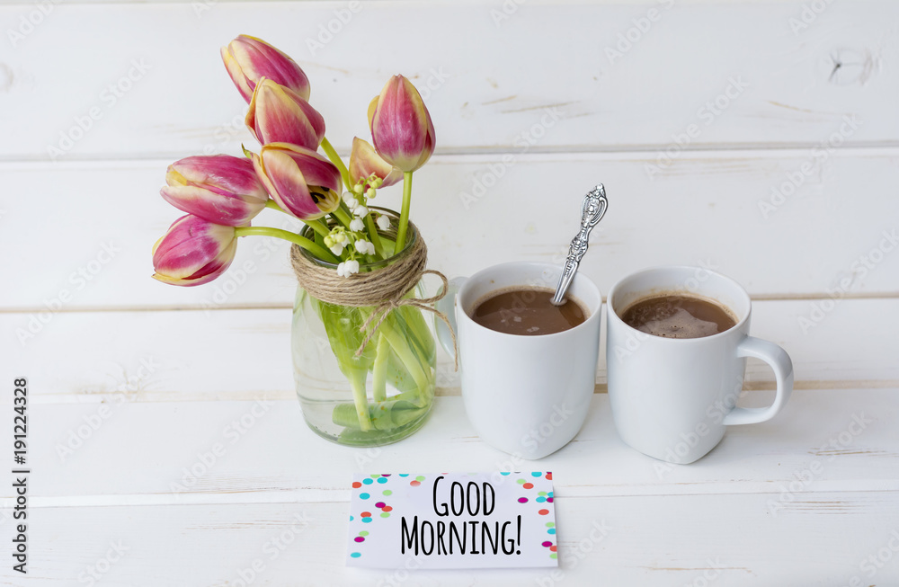 cups of aromatic coffee with tulips flowers and good morning message ...