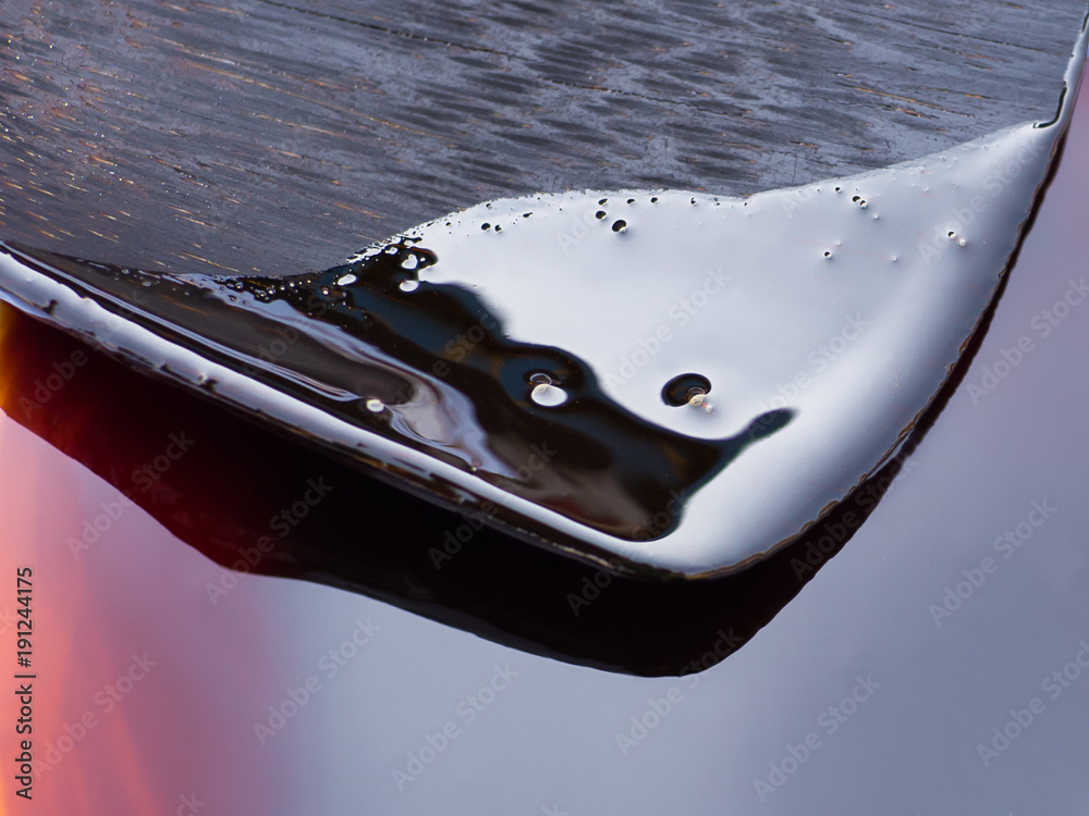 Black Molasses with wooden spoon background. Molasses is the product ...