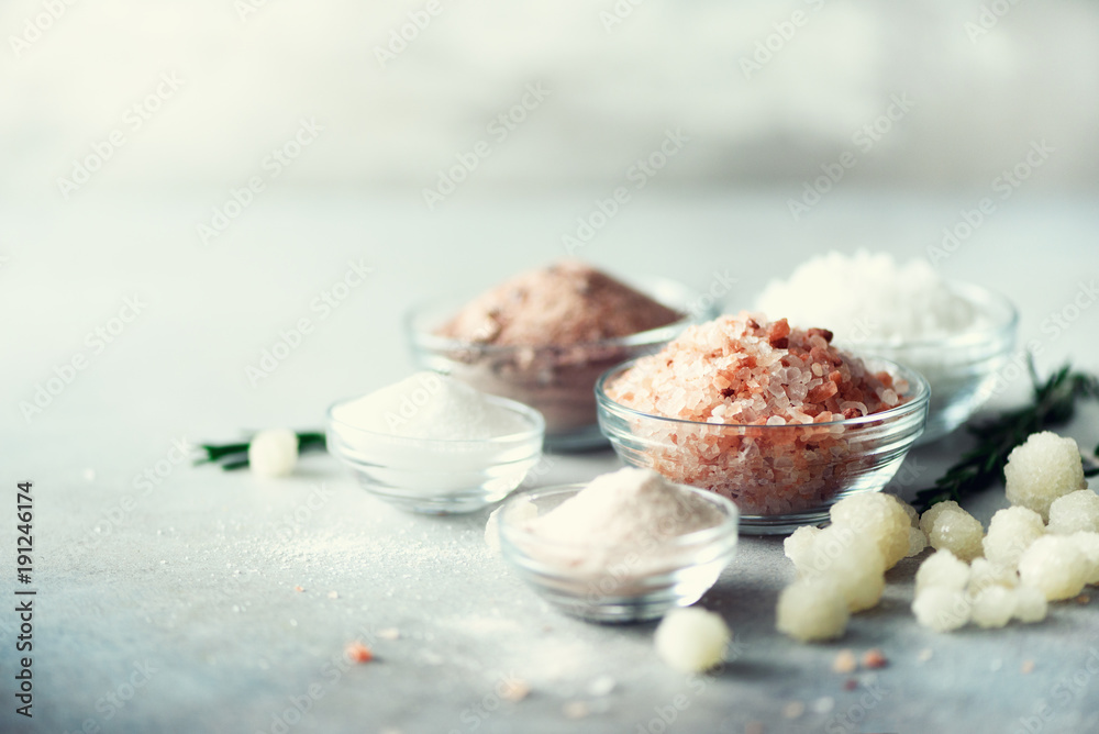 Mix of different salt types on grey concrete background. Sea salts ...