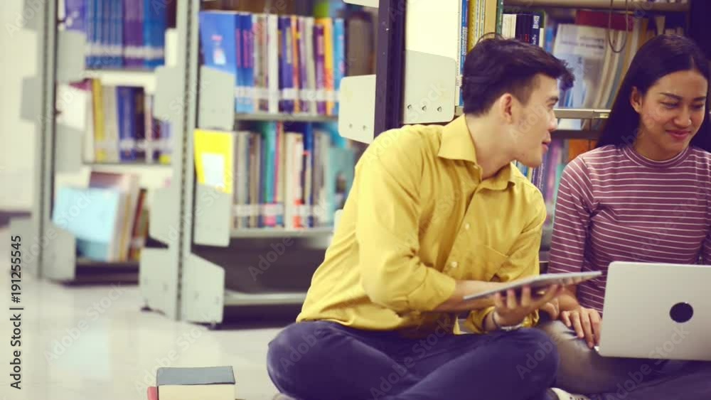 Students in library doing assignment. Attractive asian female student ...