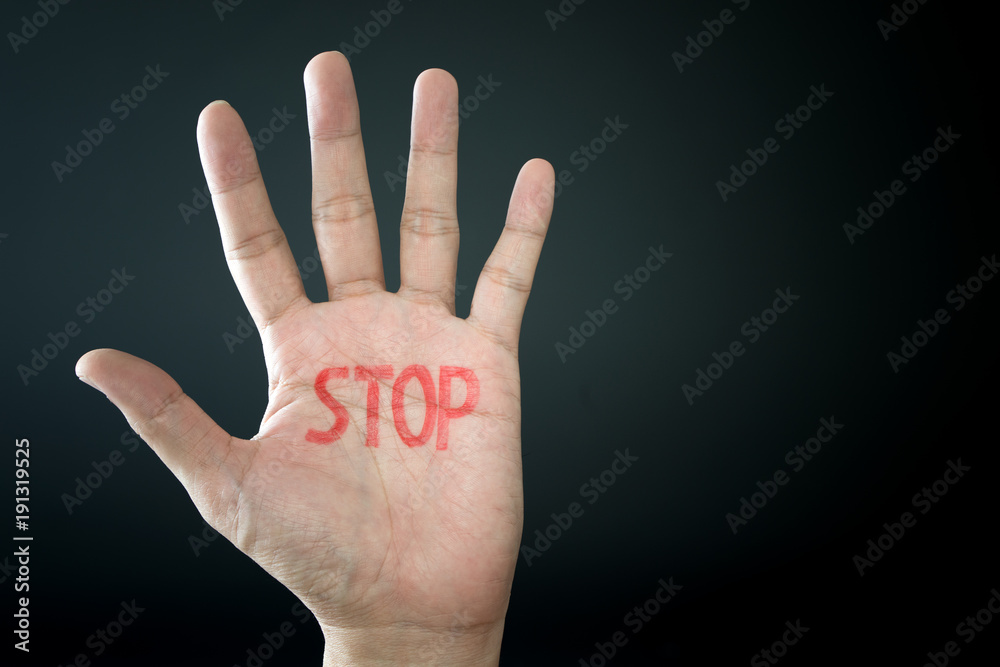 Hand with stop sign isolated on black background Stock Photo | Adobe Stock