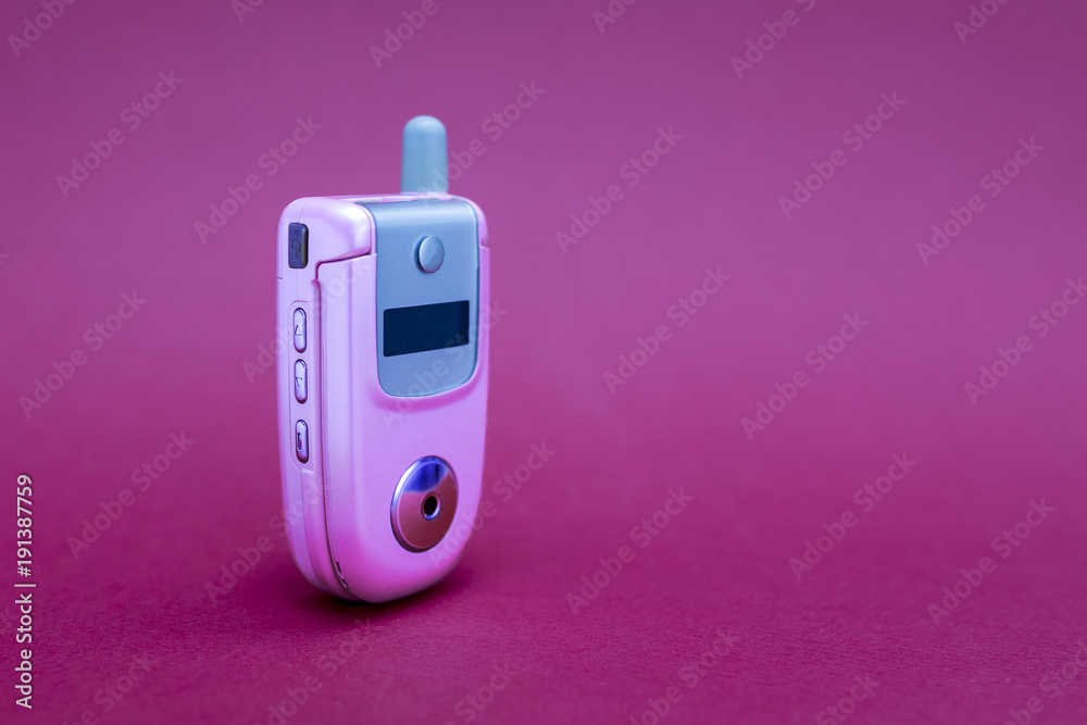 Cool and classic pink retro flip cell or mobile phone isolated against ...
