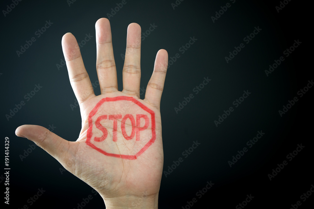 Hand with stop sign isolated on black background Stock Photo | Adobe Stock
