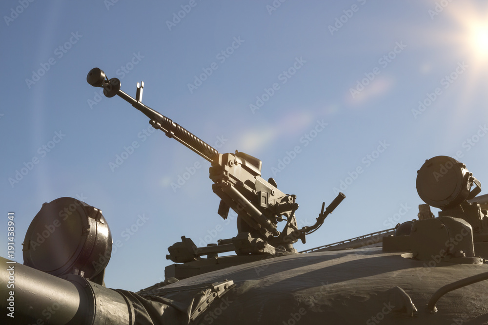weapons, a machine gun on a military armored car, a tank. against a ...