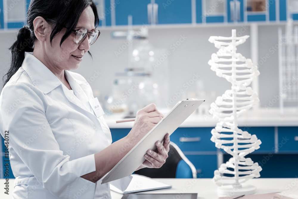 Genetic studies. Side view on a joyful female medical worker taking ...