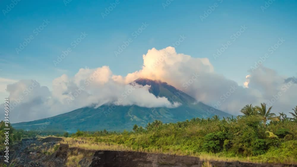 Evaporation of clouds over the Mayon volcano at sunset. Mayon Volcano ...