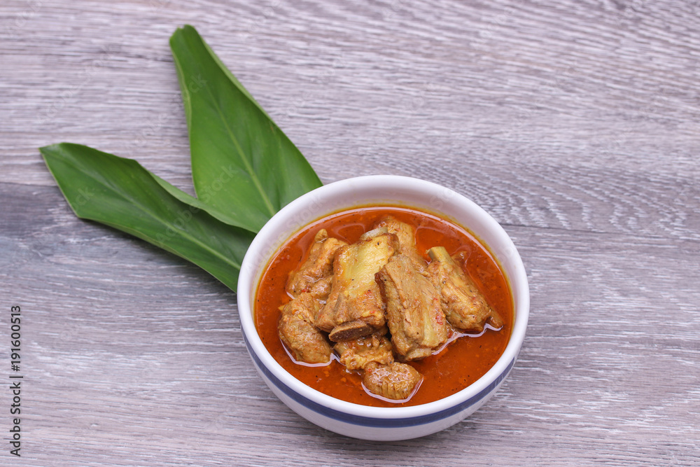 Top view of Thai Red curry with pork ribs in white bowl on Galangal ...