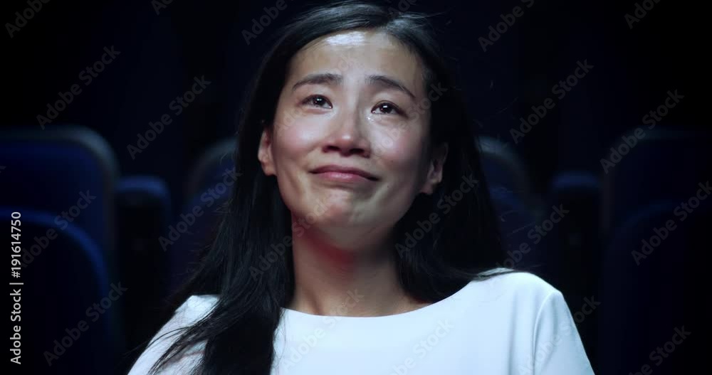 Close-up of a beautiful young Chinese woman crying happy tears while ...