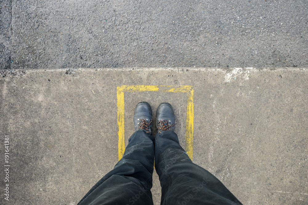 Safety sign for persons to stop before crossing the road by point the ...
