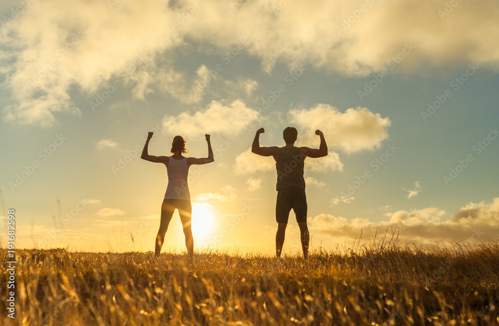 Strong man and woman sunset silhouette. Stock Photo | Adobe Stock
