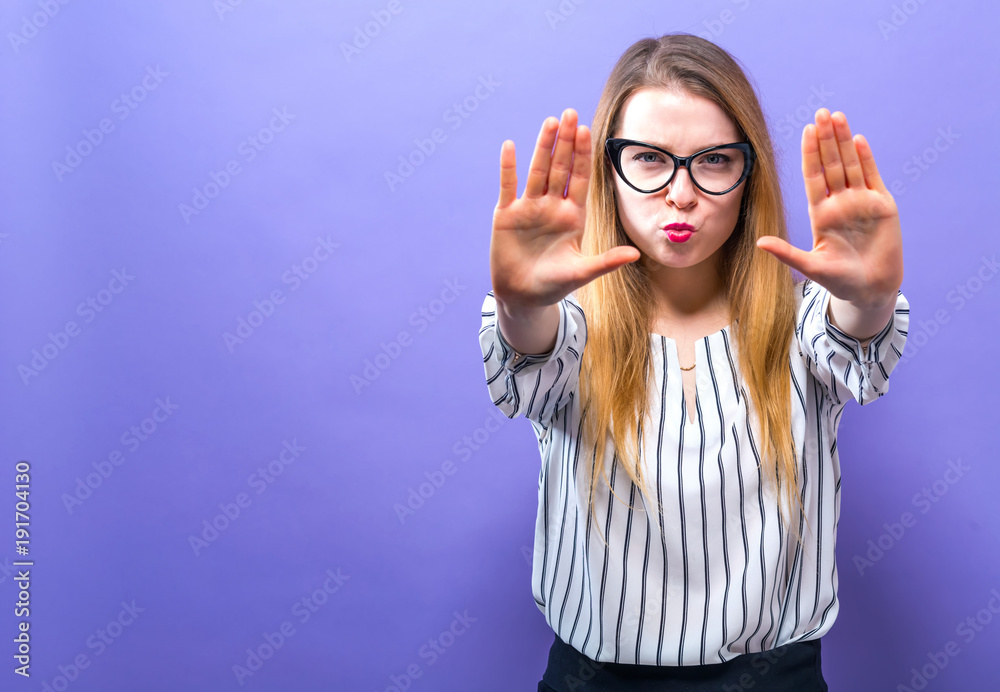 Young woman making a rejection pose on a solid background Stock Photo ...