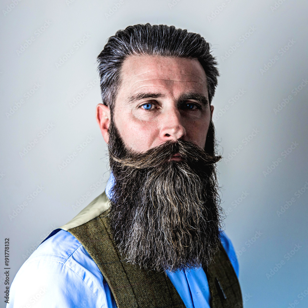 Smart man with a beard and moustache wearing a suit Stock Photo | Adobe ...