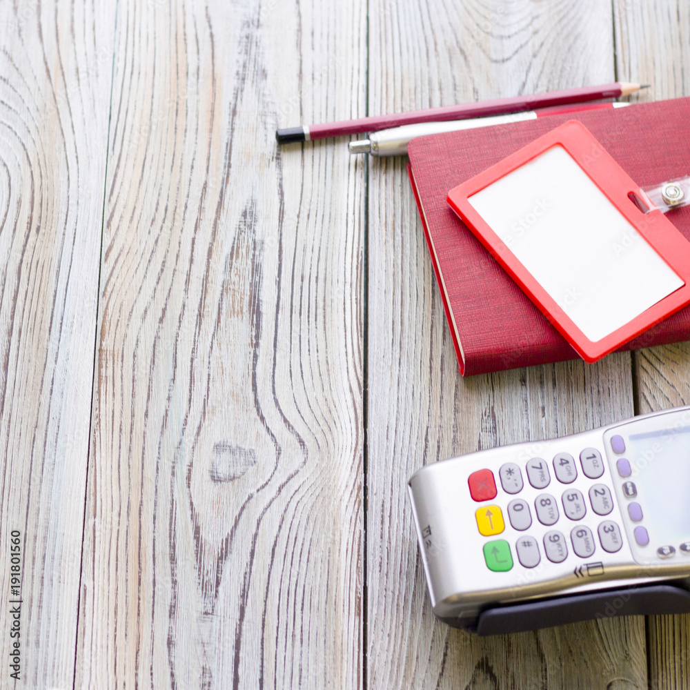 Modern technology and people concept - pos terminal, notepad, a pen and ...