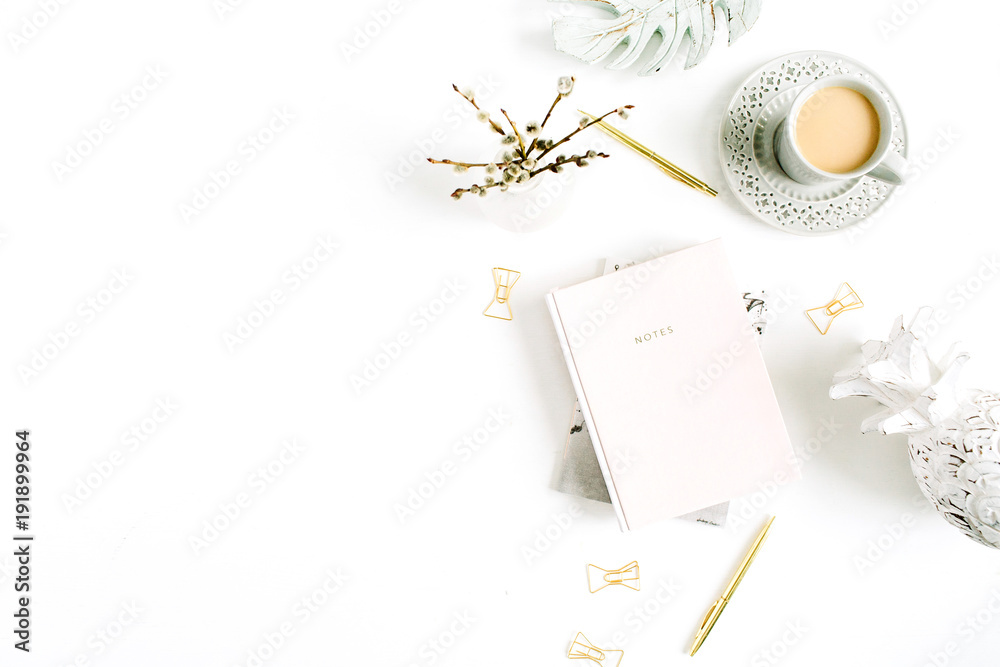 Workspace with pale pastel pink notebook and decorations on white ...