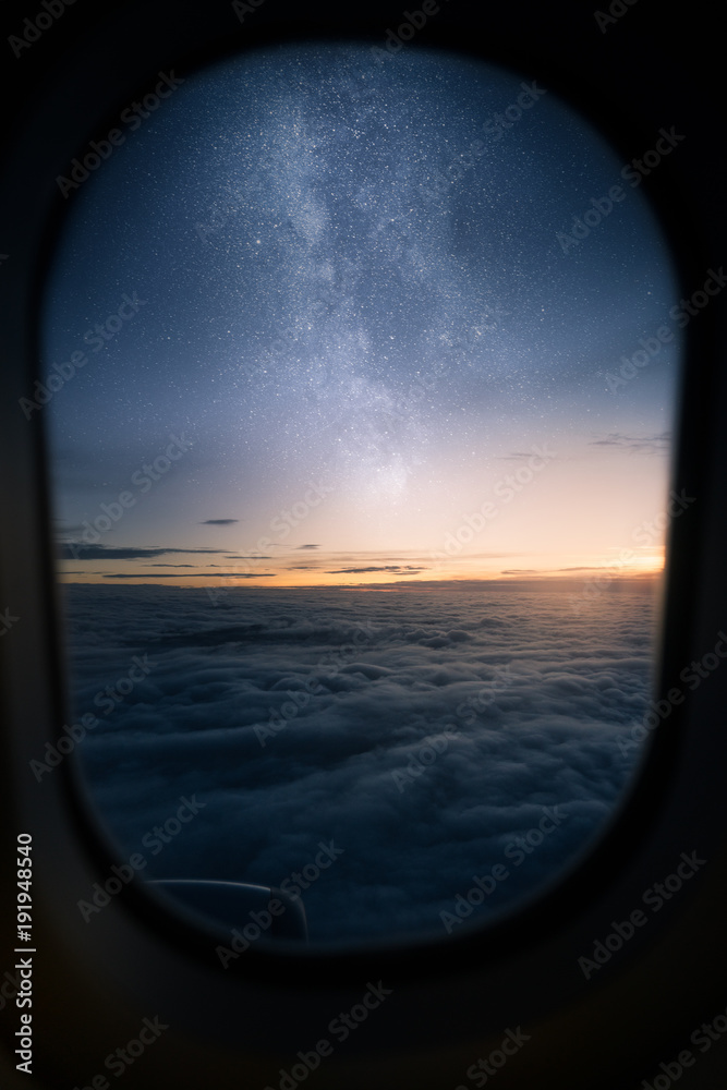 Beautiful view out of airplane window above clouds during sunrise with ...