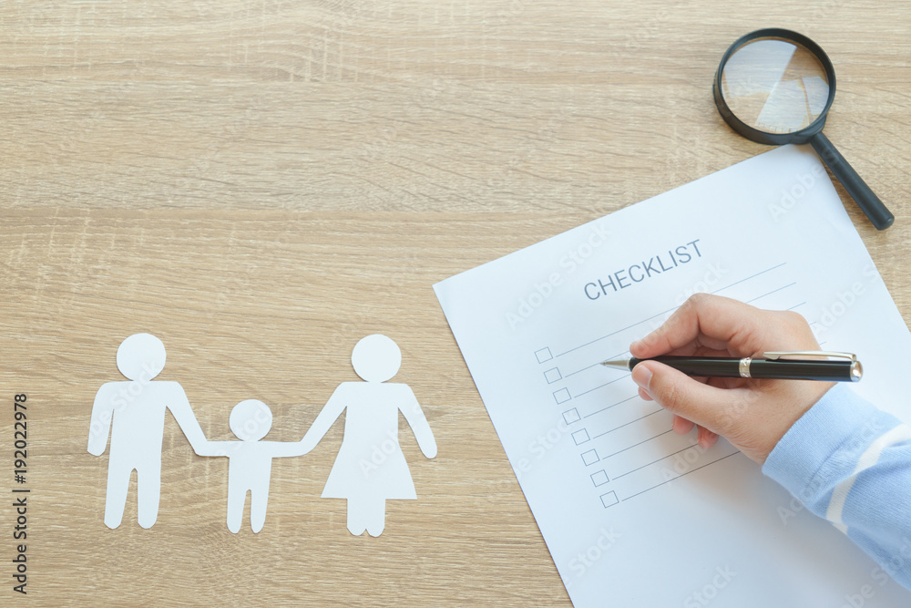 Hands writing checklist with annual health of family - to do list, goal ...