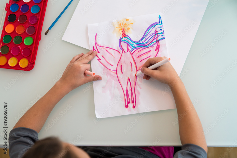 Young girl drawing, overhead view. Stock Photo | Adobe Stock