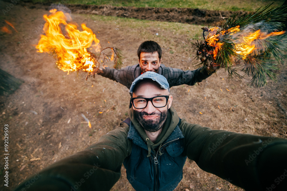 Frineds make selfie. Crazy funny boys mess around. Men at nature ...