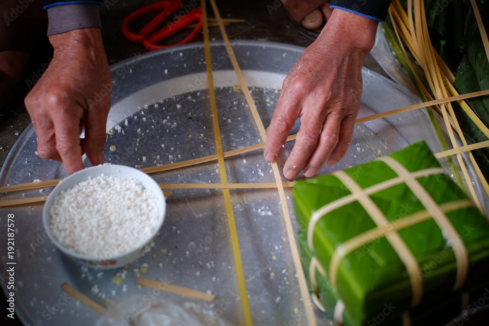 Packing Banh Chung (sticky rice cake), this is a traditional Vietnamese ...