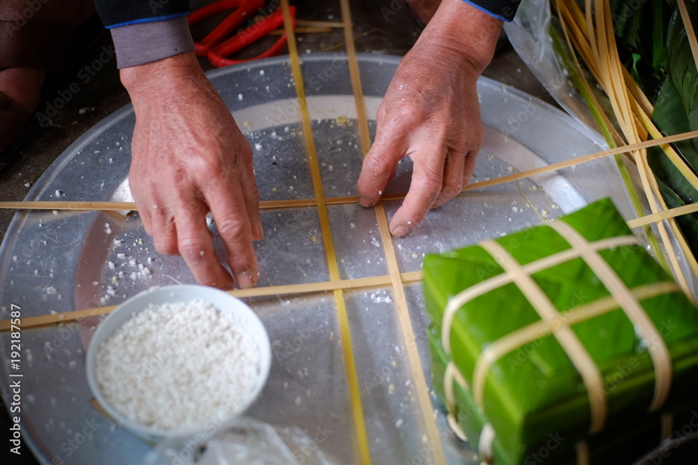 Packing Banh Chung (sticky rice cake), this is a traditional Vietnamese ...