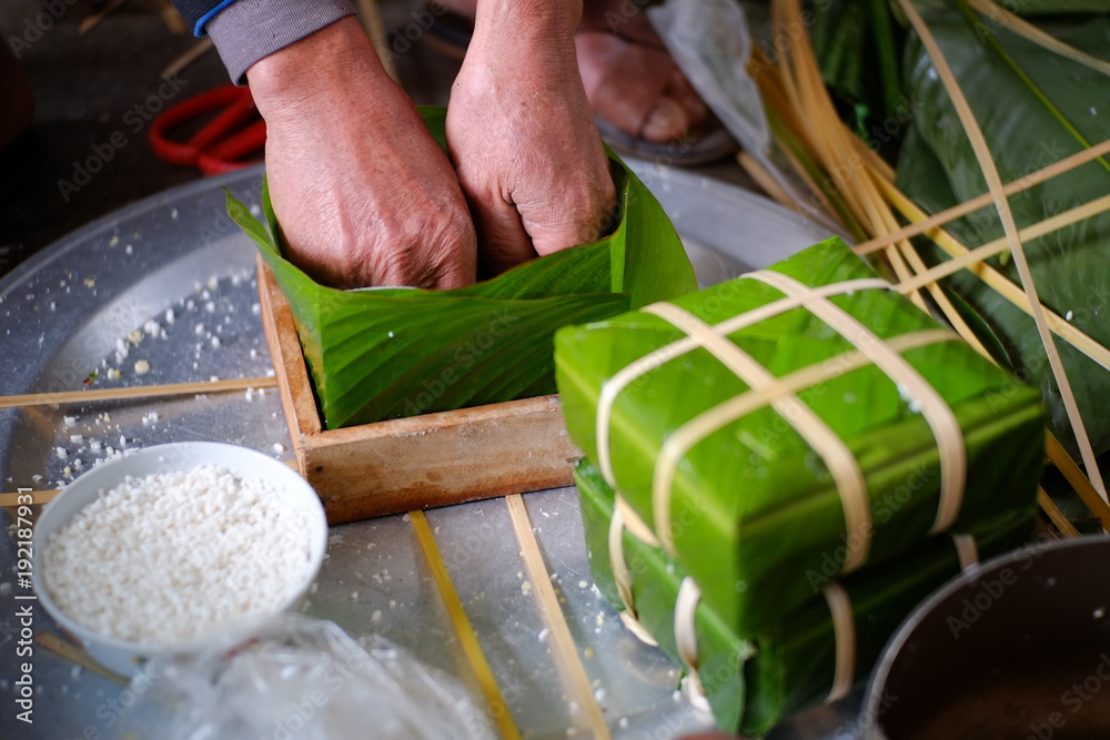 Packing Banh Chung (sticky rice cake), this is a traditional Vietnamese ...