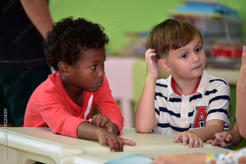 children having fun on learning in an international school library ...