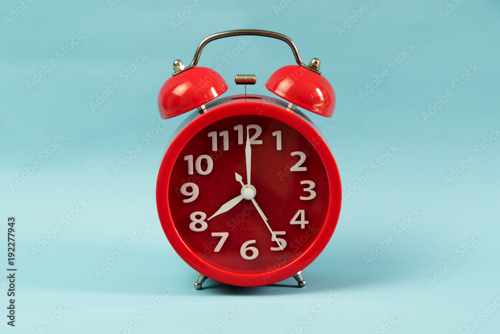 Red alarm clock on blue pastel background Stock Photo | Adobe Stock