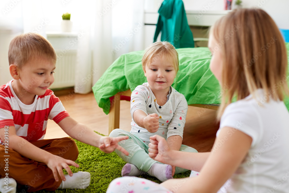 kids playing rock-paper-scissors game at home Stock Photo | Adobe Stock