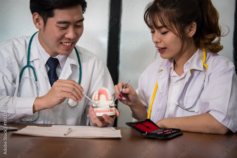 dentist co worker discussing patient treatment with jaw teeth ...