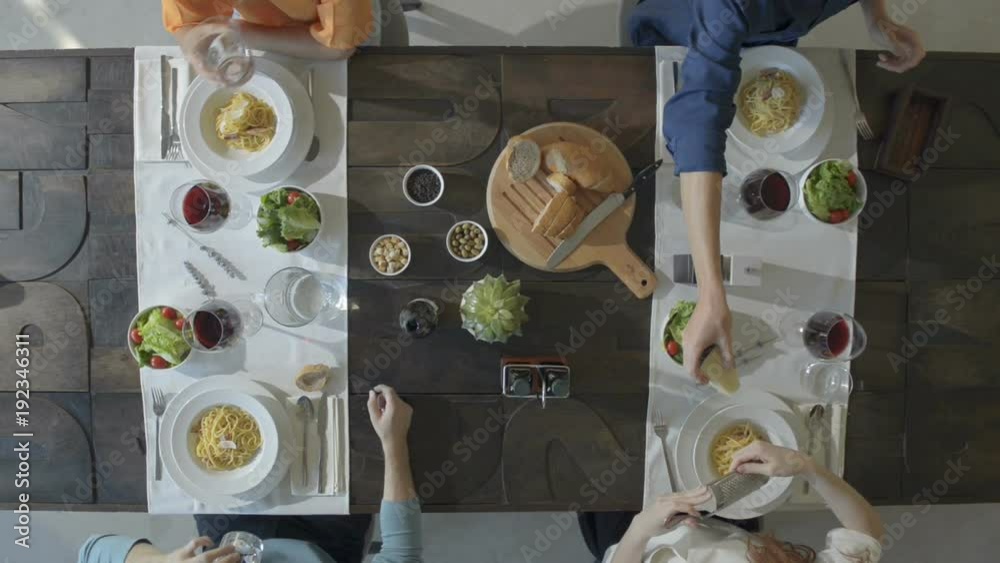 Overhead top view table four caucasian friends eating carbonara italian ...