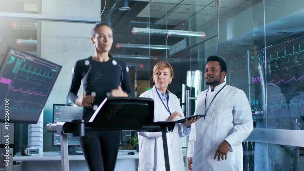 Woman Athlete Runs on a Treadmill with Electrodes Attached to Her Body ...