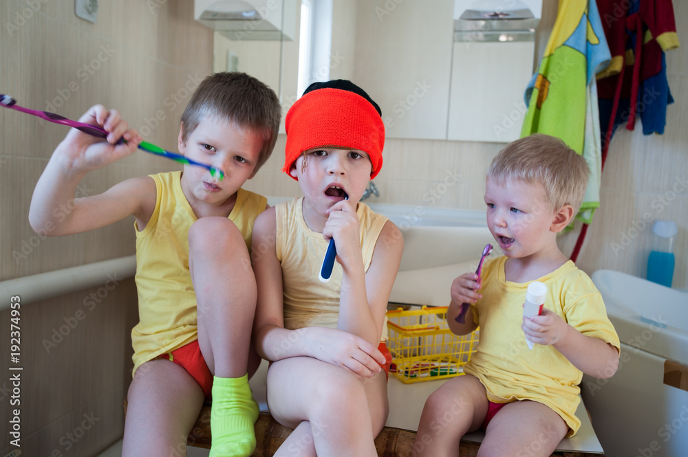 Happy little twins children and baby brother playing together with ...