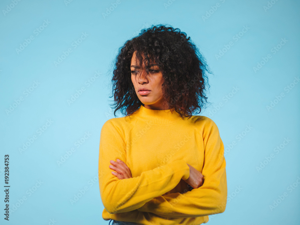 Angry annoyed young housewife keeping arms crossed and staring at ...