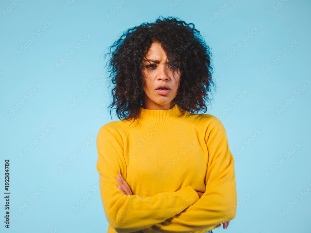 Angry annoyed young housewife keeping arms crossed and staring at ...