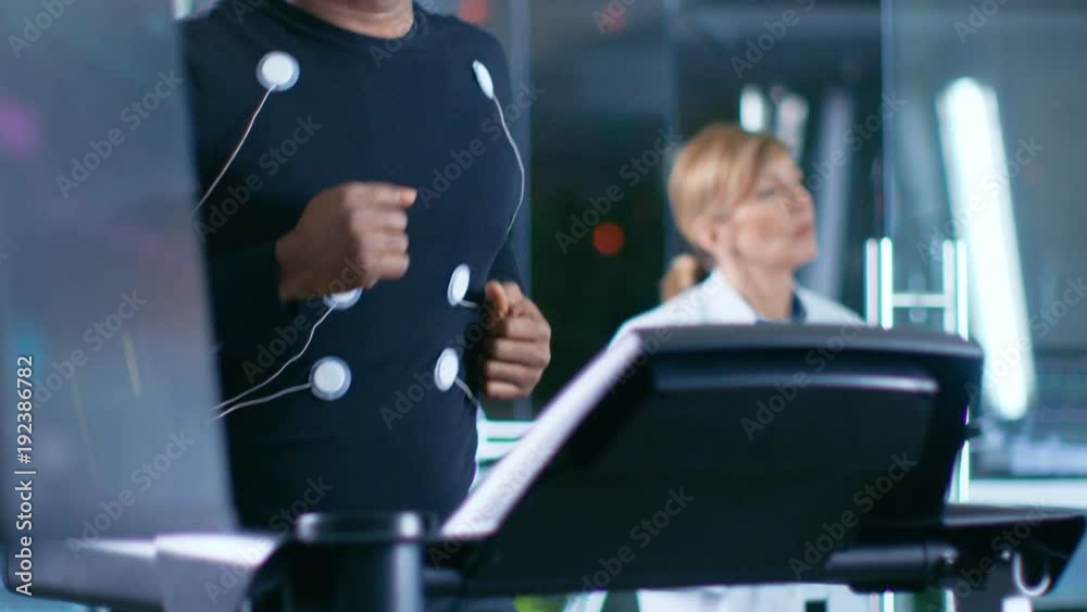 Male Athlete Runs on a Treadmill with Electrodes Attached to His Body ...