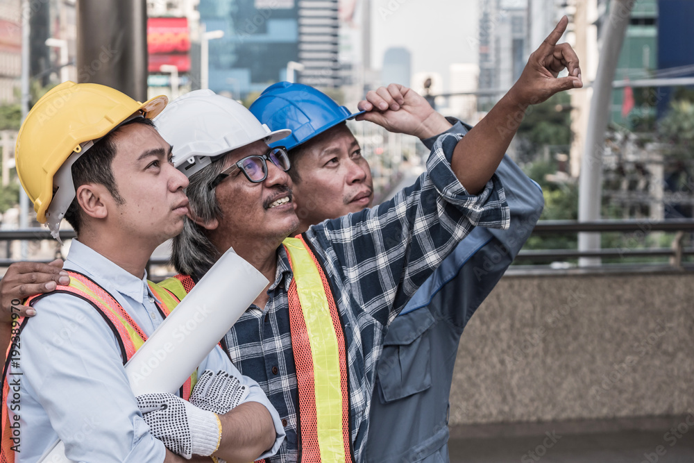 Architect, civil engineer and worker at construction site working ...